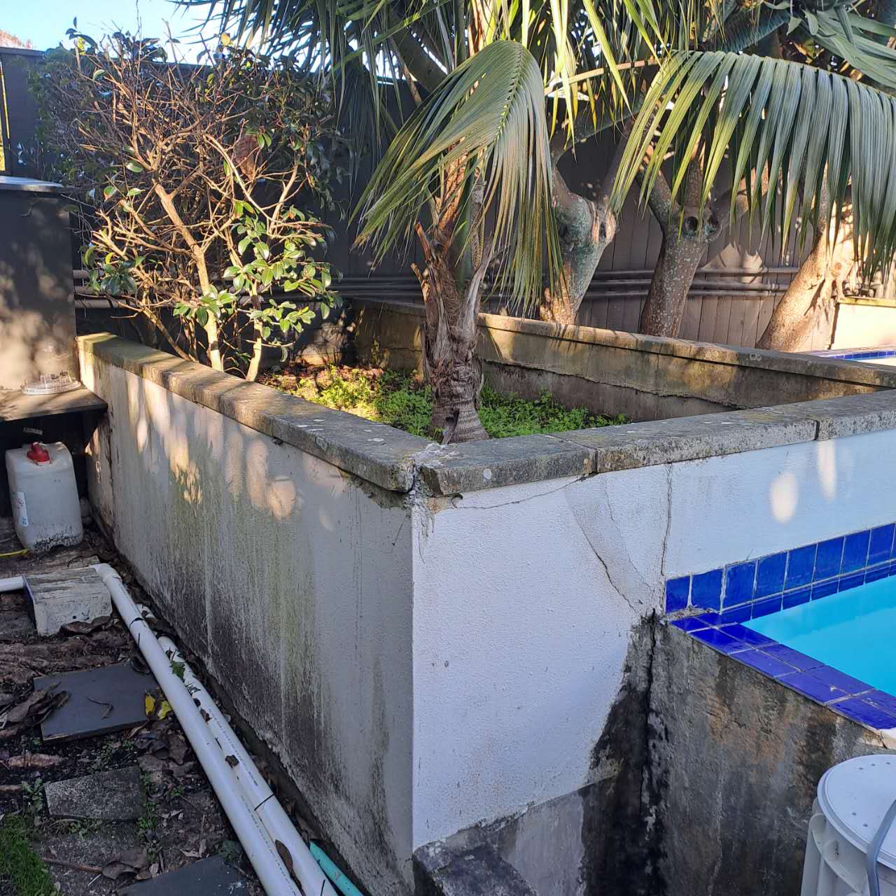 Rendered Retaining Wall Repair Needed (Cracks + Moisture Damage ...